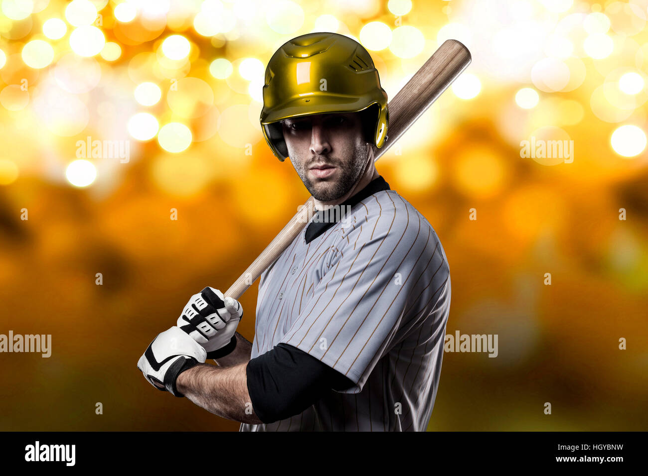 Baseball Player on a yellow Uniform on yellow lights background Stock ...