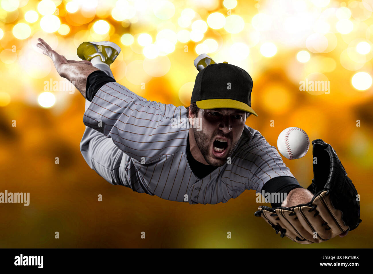 Baseball Player on a yellow Uniform on yellow lights background Stock ...