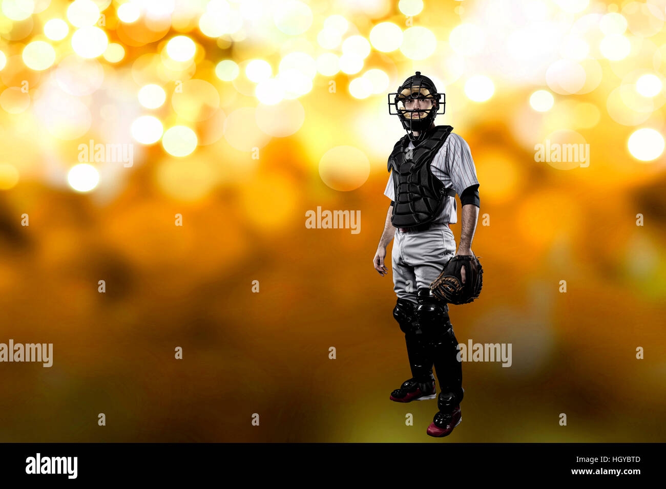 Catcher Baseball Player on a yellow lights background Stock Photo - Alamy