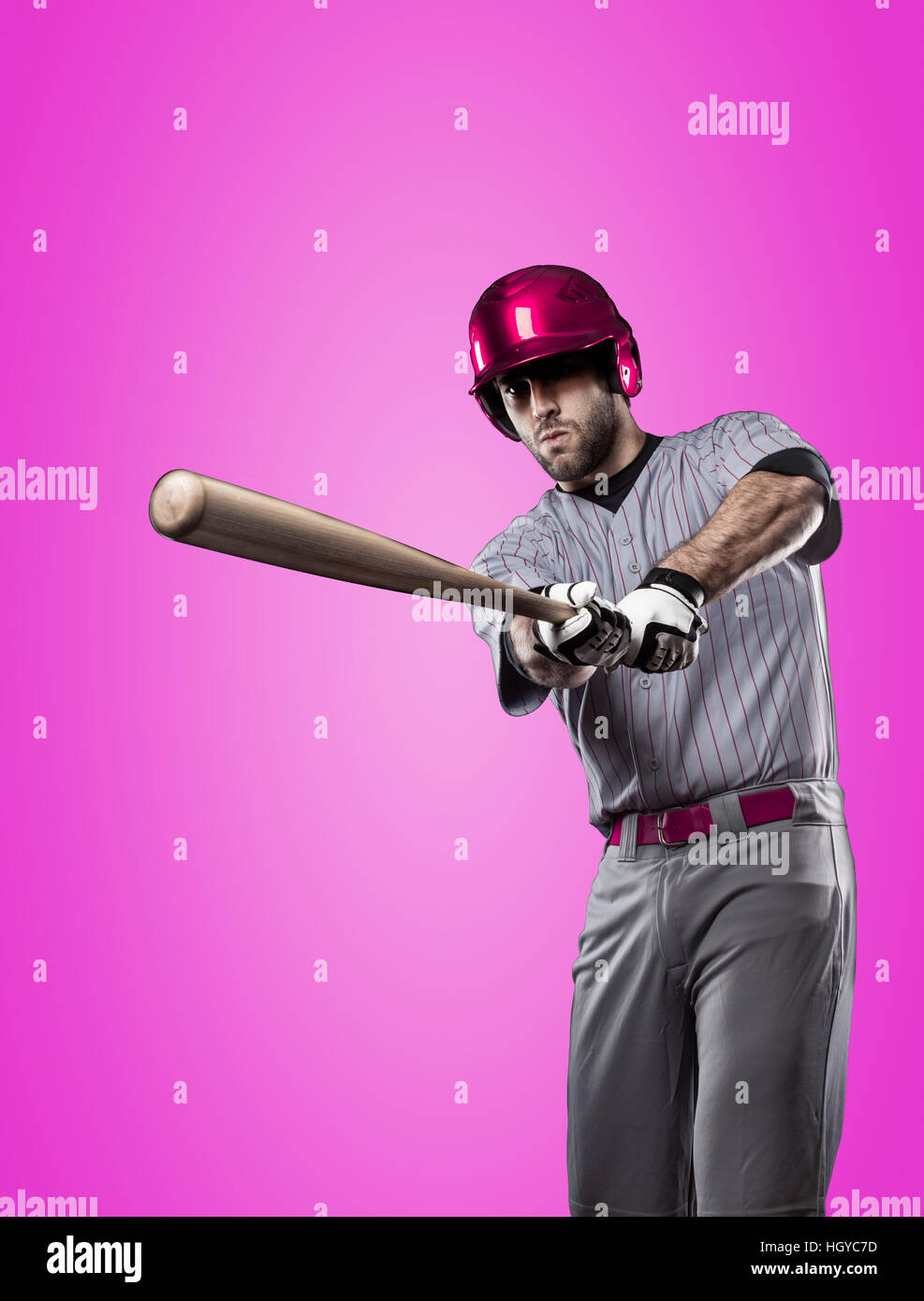 Baseball Player on a pink Uniform on pink background Stock Photo - Alamy