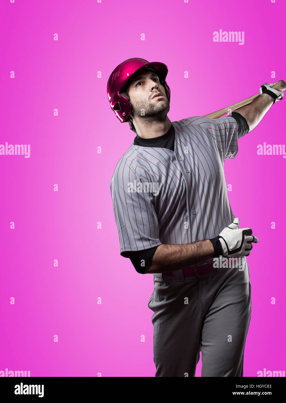 Baseball Player on a pink Uniform on pink background Stock Photo - Alamy