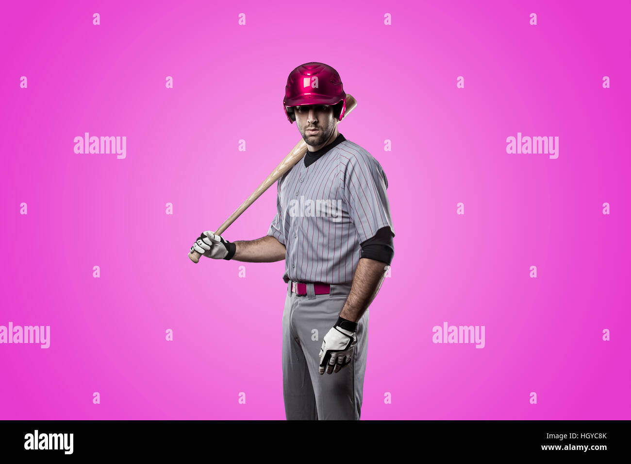Baseball Player on a pink Uniform on pink background Stock Photo - Alamy