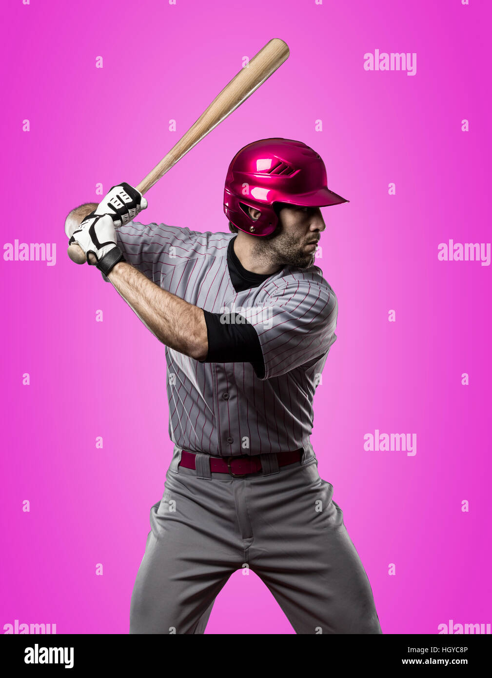 Baseball Player on a pink Uniform on pink background Stock Photo - Alamy
