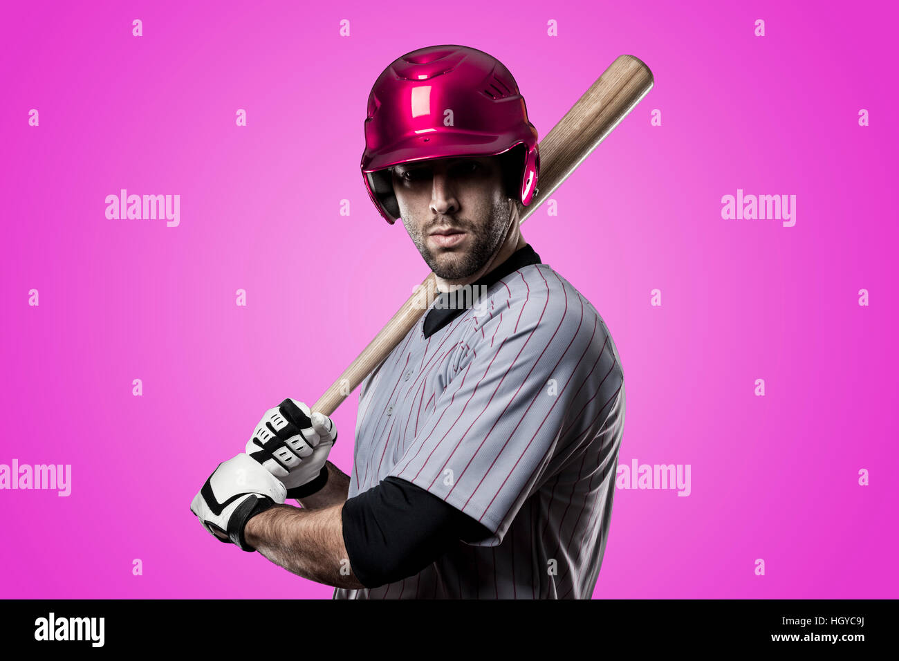 Baseball Player on a pink Uniform on pink background Stock Photo - Alamy