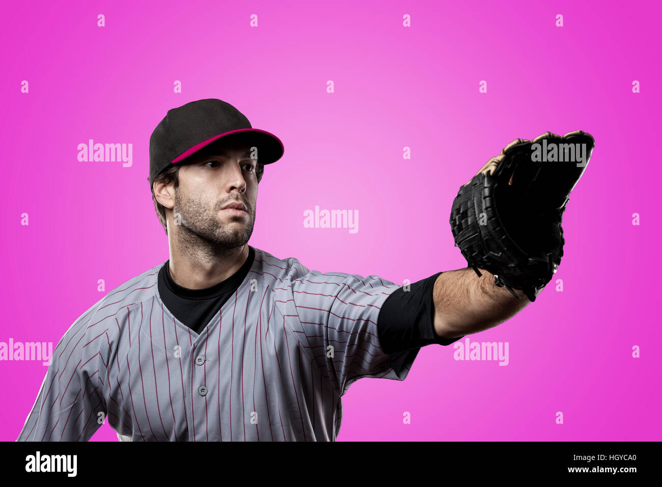 Baseball Player on a pink Uniform on pink background Stock Photo - Alamy