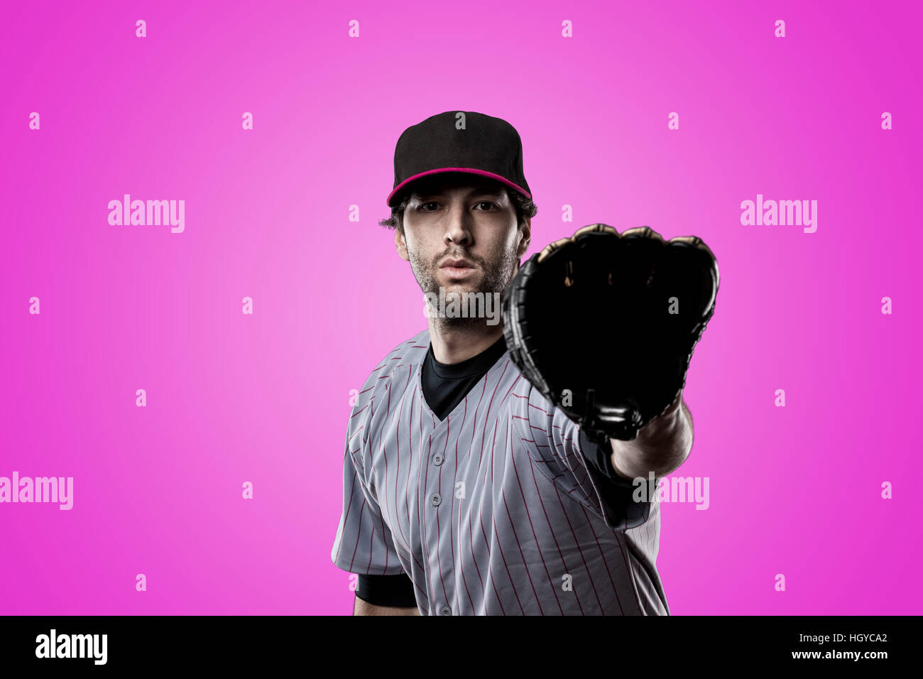 Baseball Player on a pink Uniform on pink background Stock Photo - Alamy