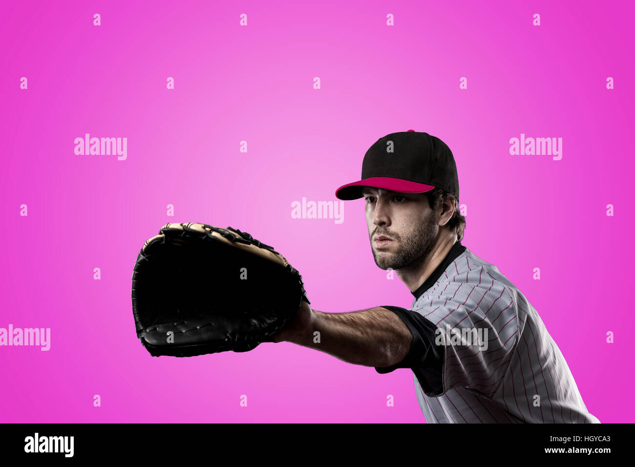 Baseball Player on a pink Uniform on pink background Stock Photo - Alamy