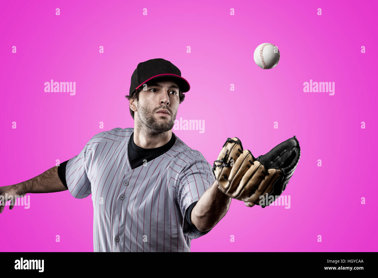 Baseball Player on a pink Uniform on pink background Stock Photo - Alamy