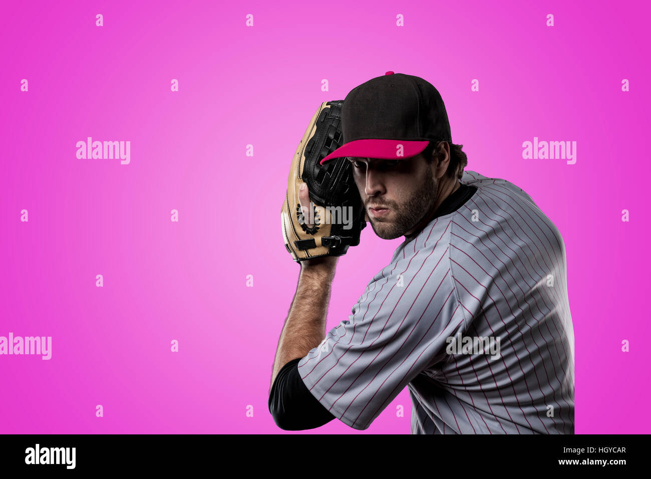 Baseball Player on a pink Uniform on pink background Stock Photo - Alamy