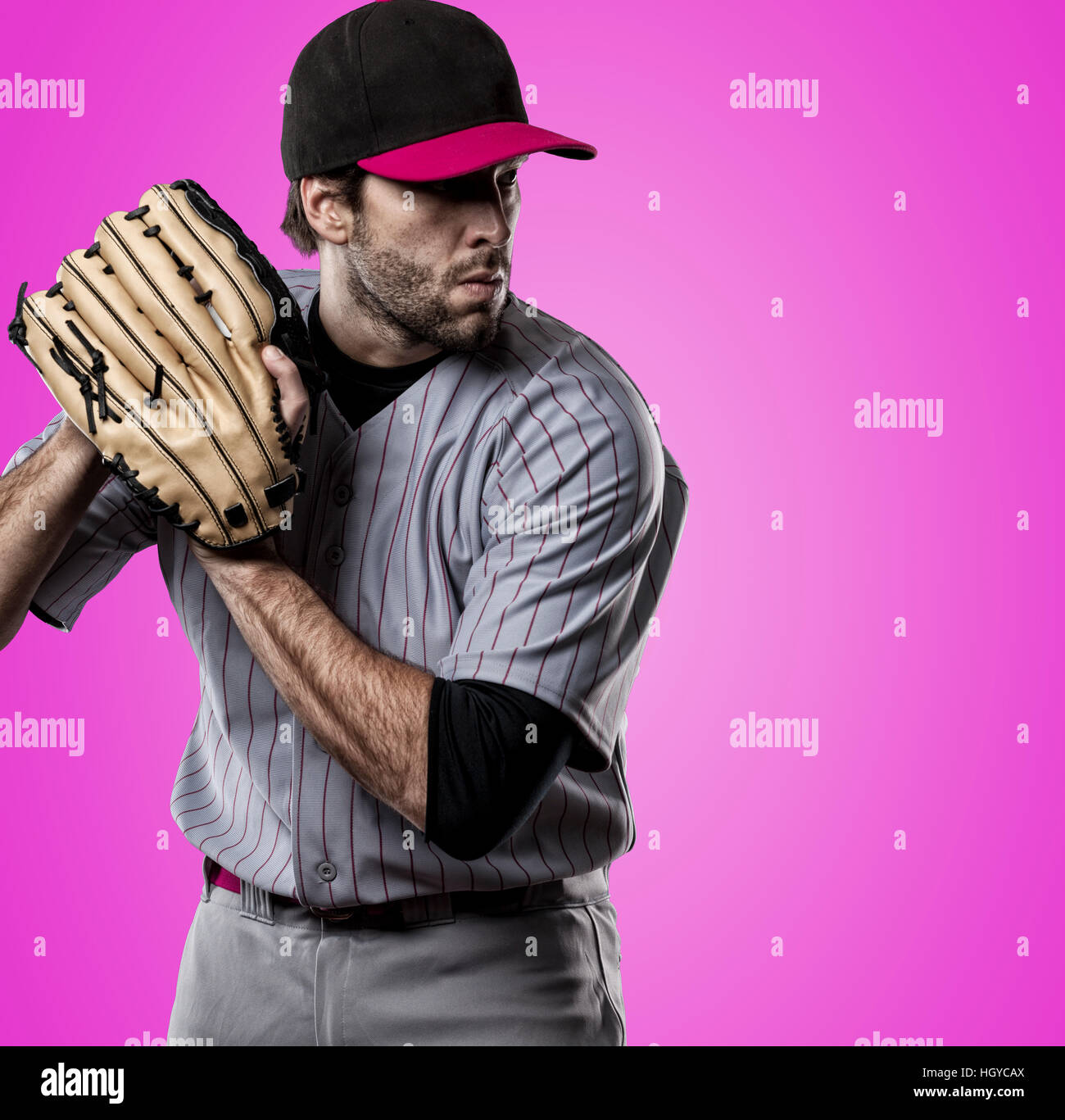 Baseball Player on a pink Uniform on pink background Stock Photo - Alamy
