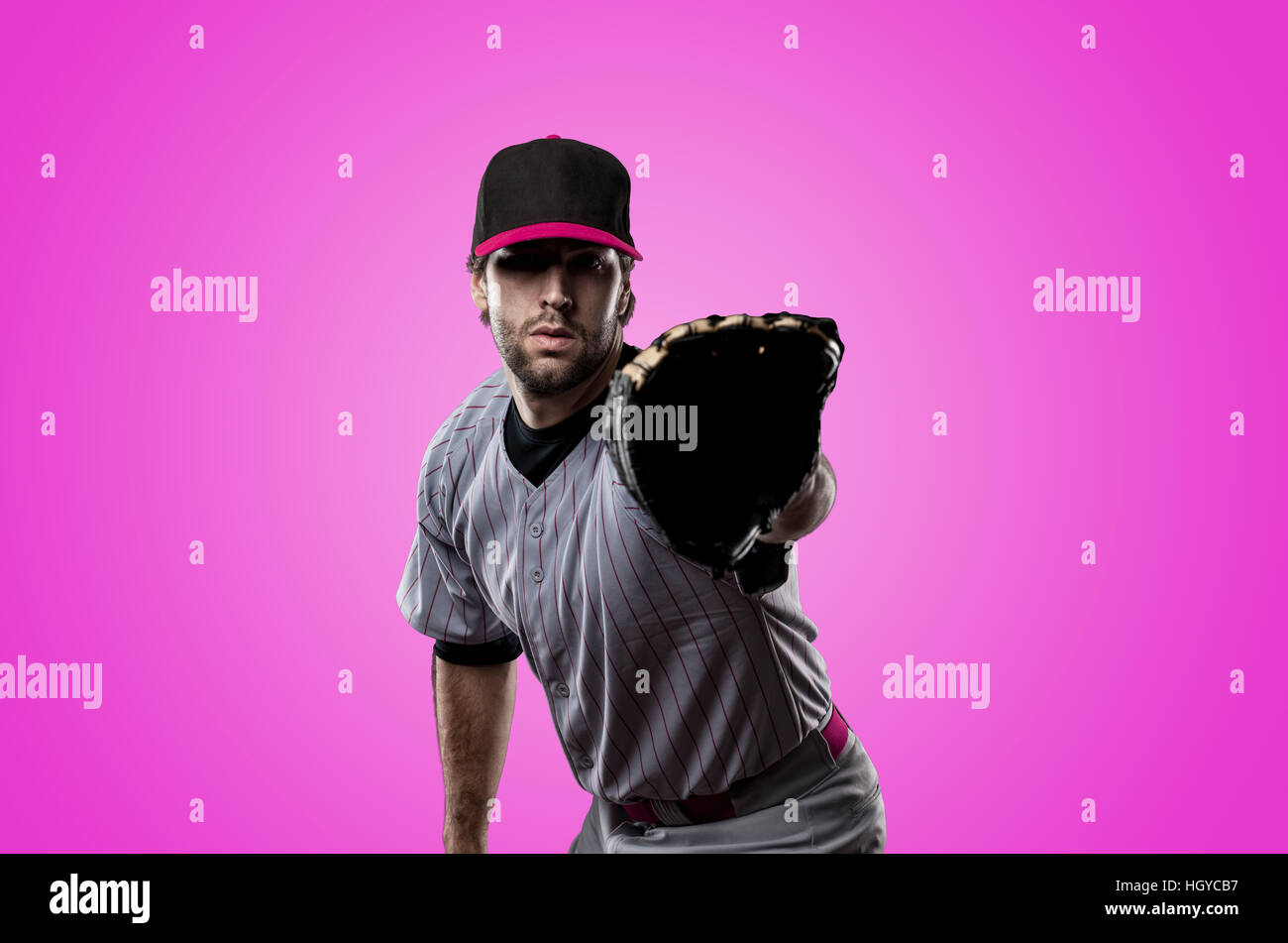 Baseball Player on a pink Uniform on pink background Stock Photo - Alamy