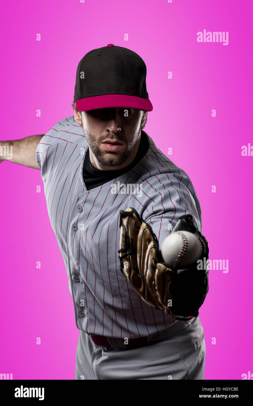 Baseball Player on a pink Uniform on pink background Stock Photo - Alamy