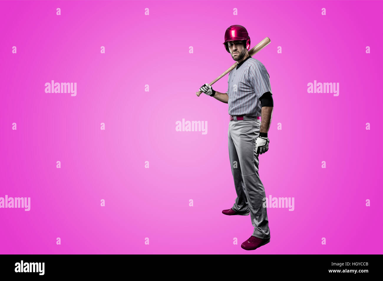 Baseball Player on a pink Uniform on pink background Stock Photo - Alamy