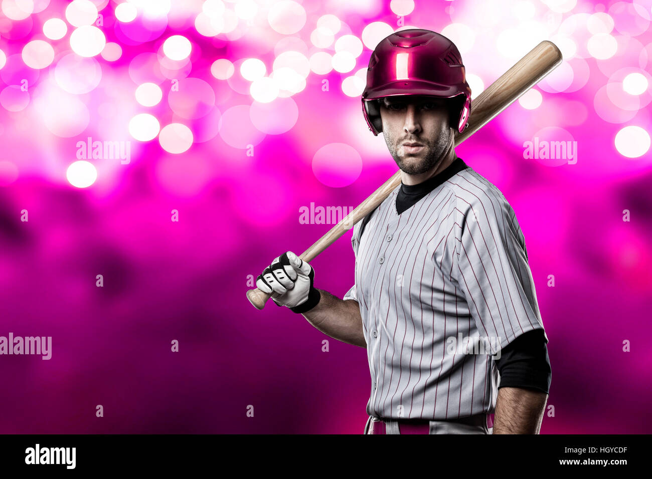 Baseball Player on a pink Uniform on pink lights background Stock Photo ...