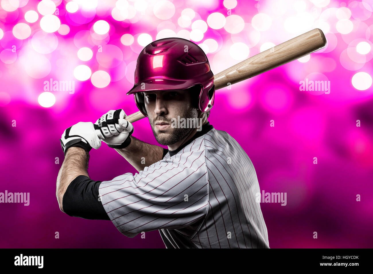 Baseball Player on a pink Uniform on pink lights background Stock Photo ...