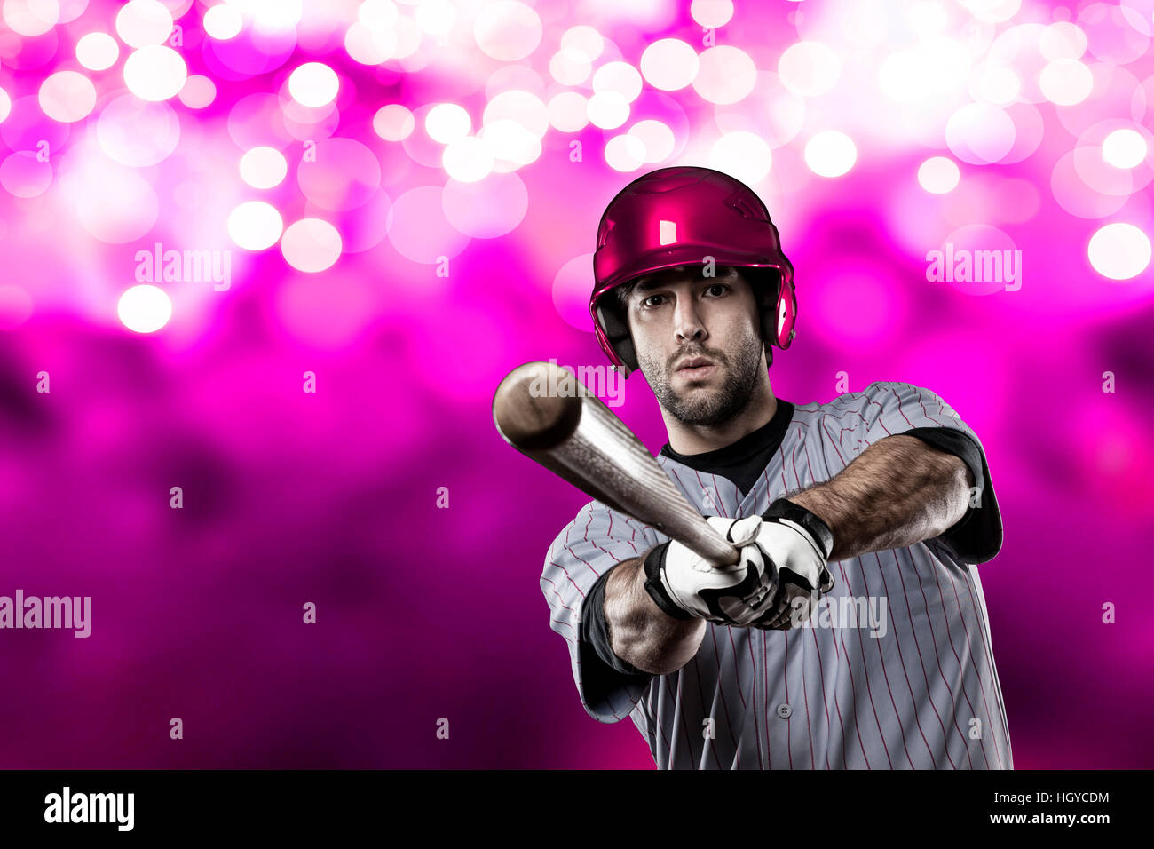 Baseball Player on a pink Uniform on pink lights background Stock Photo ...