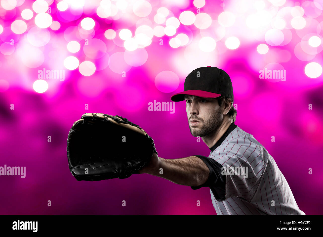 Baseball Player on a pink Uniform on pink lights background Stock Photo ...