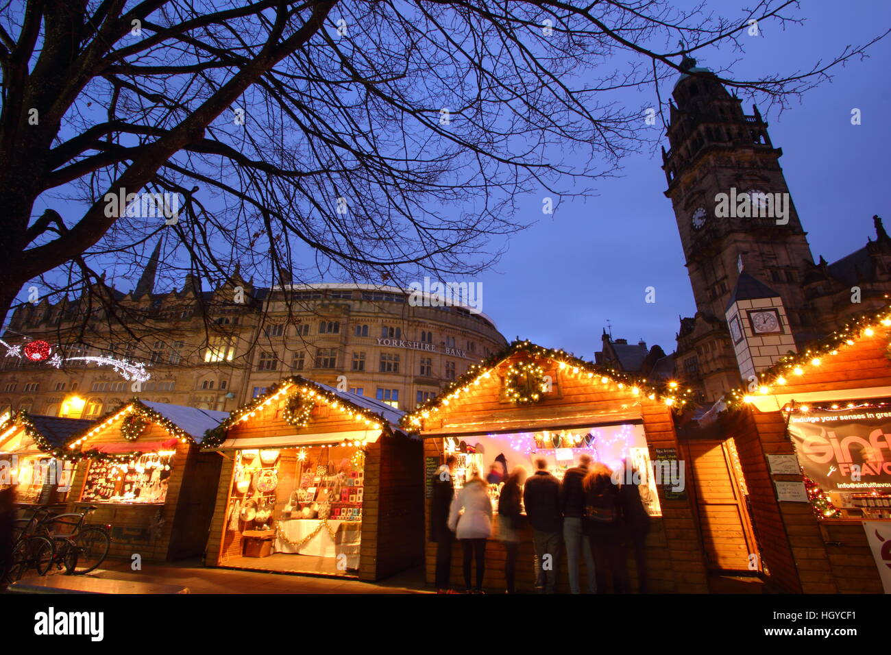 Shoppers at the Christmas market in the shadow of the town hall ...