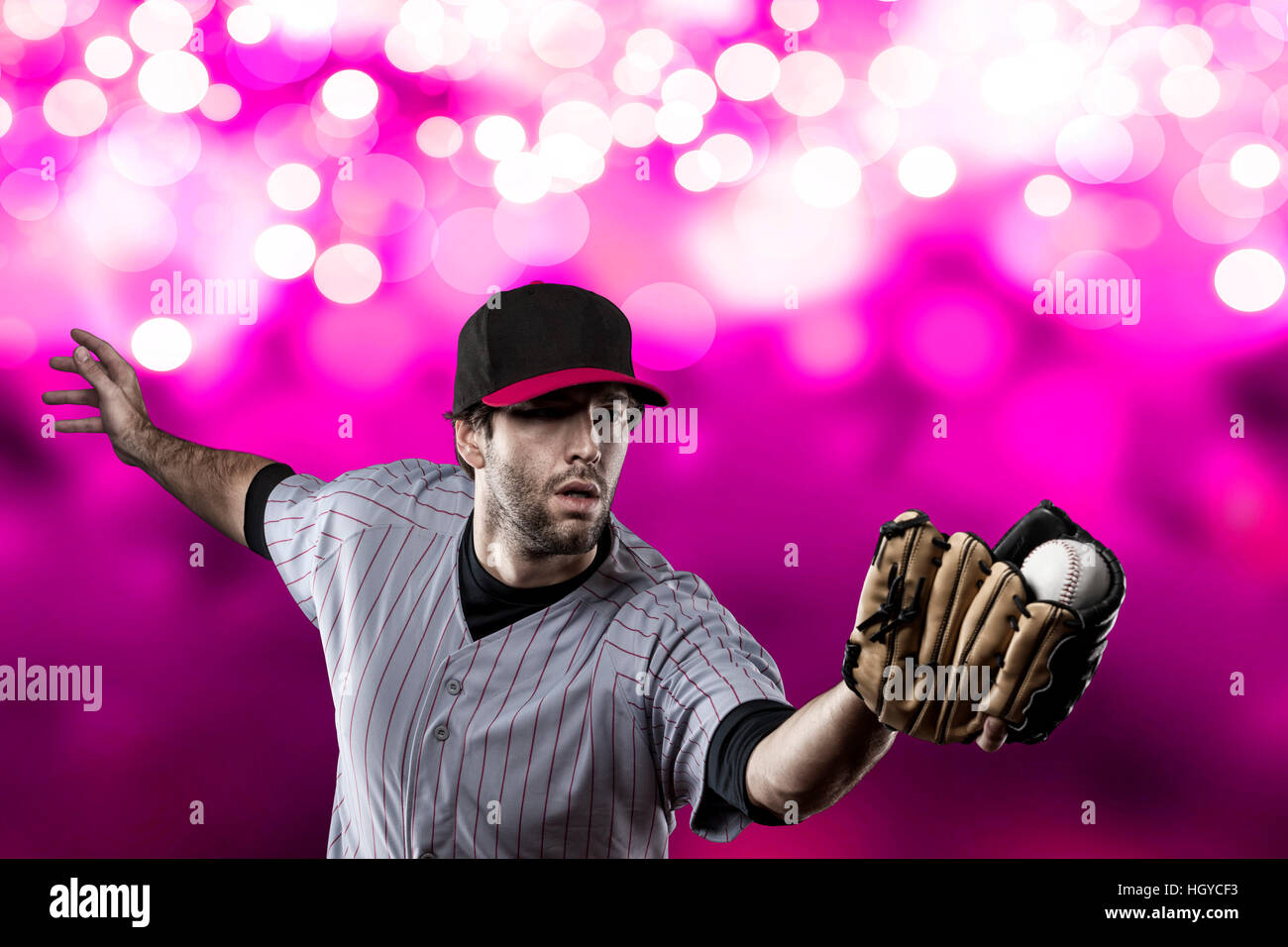 Baseball Player on a pink Uniform on pink lights background Stock Photo ...
