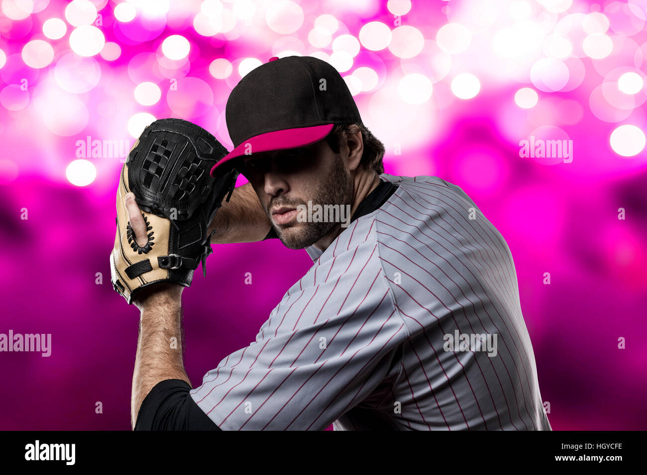 Baseball Player on a pink Uniform on pink lights background Stock Photo ...