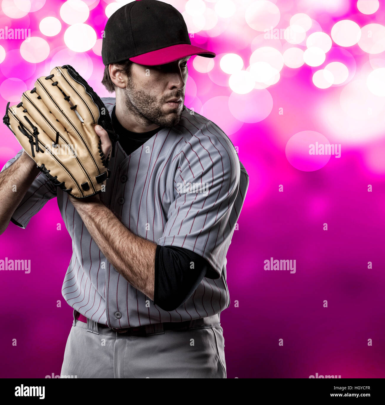 Baseball Player on a pink Uniform on pink lights background Stock Photo ...