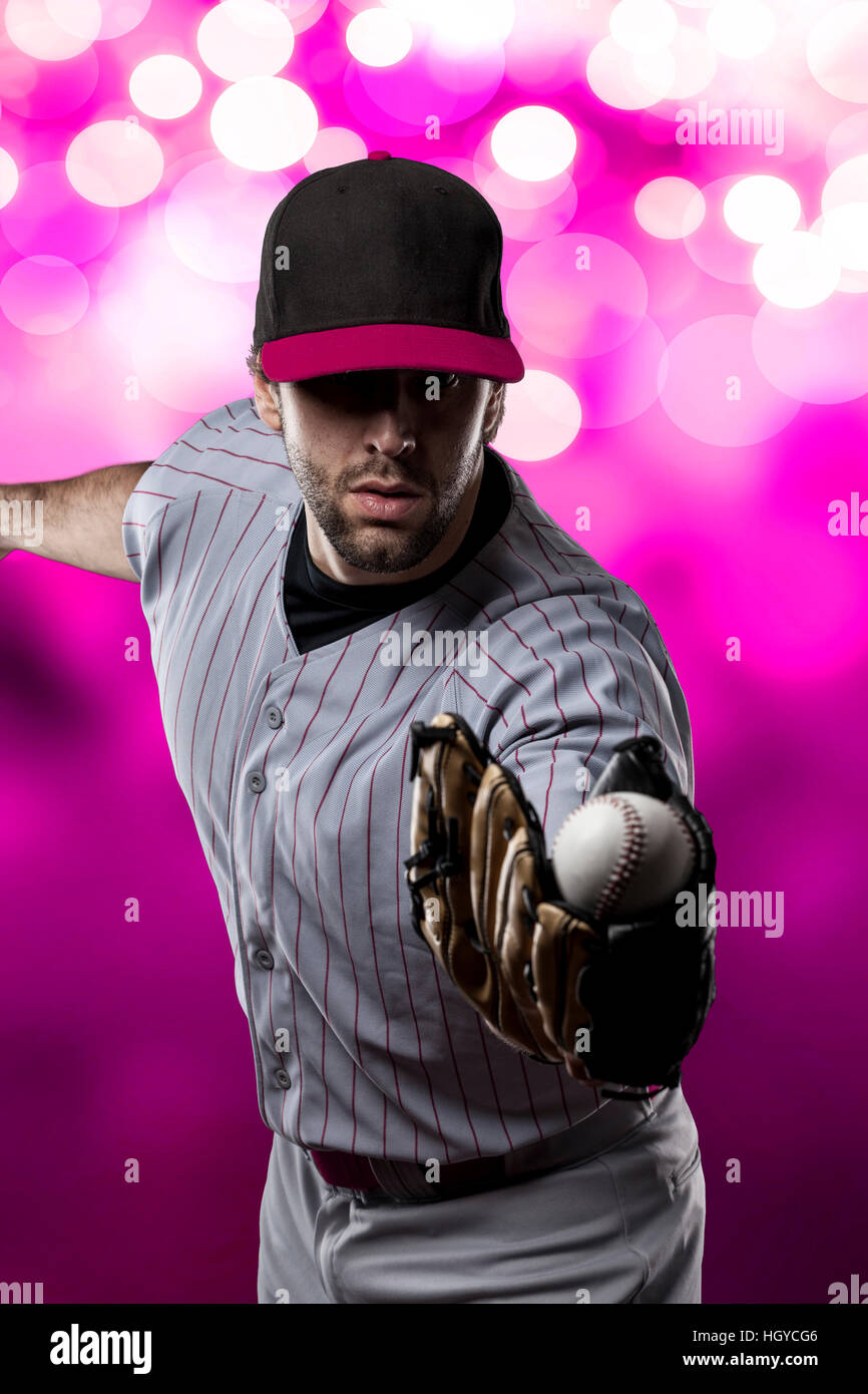 Baseball Player on a pink Uniform on pink lights background Stock Photo ...