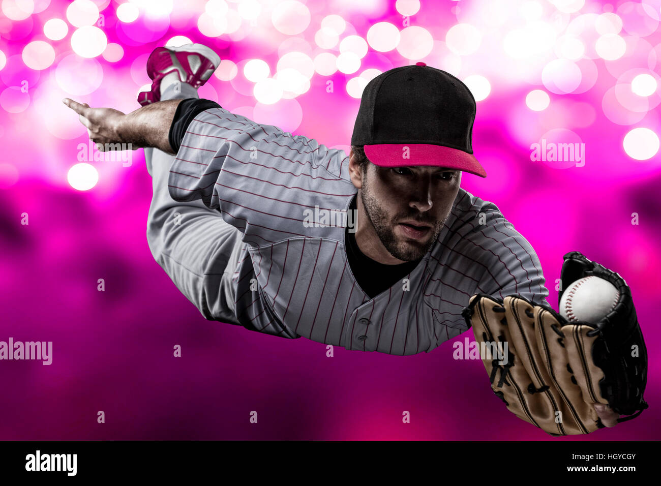 Baseball Player on a pink Uniform on pink lights background Stock Photo ...