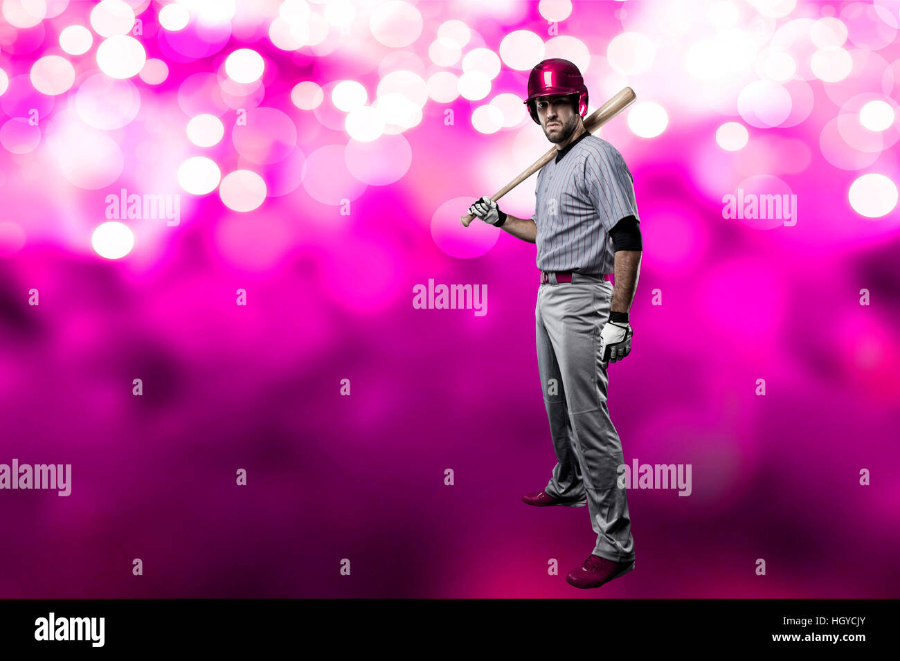 Baseball Player on a pink Uniform on pink lights background Stock Photo ...