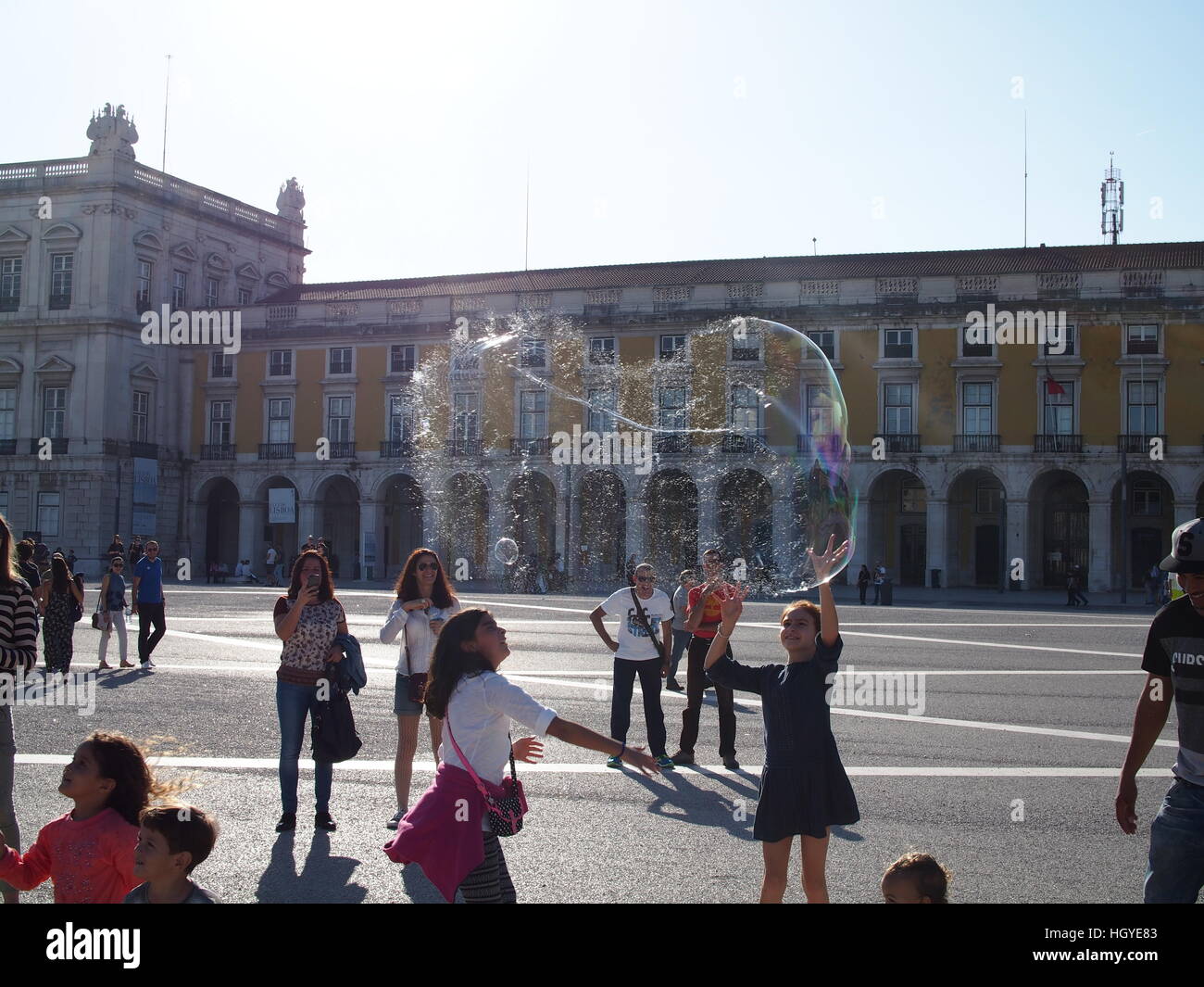 Children popping bubbles in public square Stock Photo - Alamy