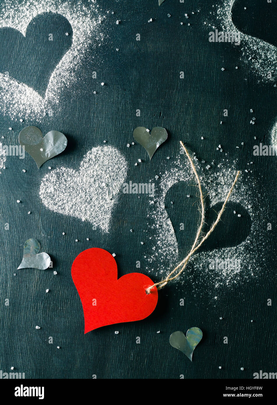 Card for Valentine's Day. Red paper heart on a rope. Strict dark ...