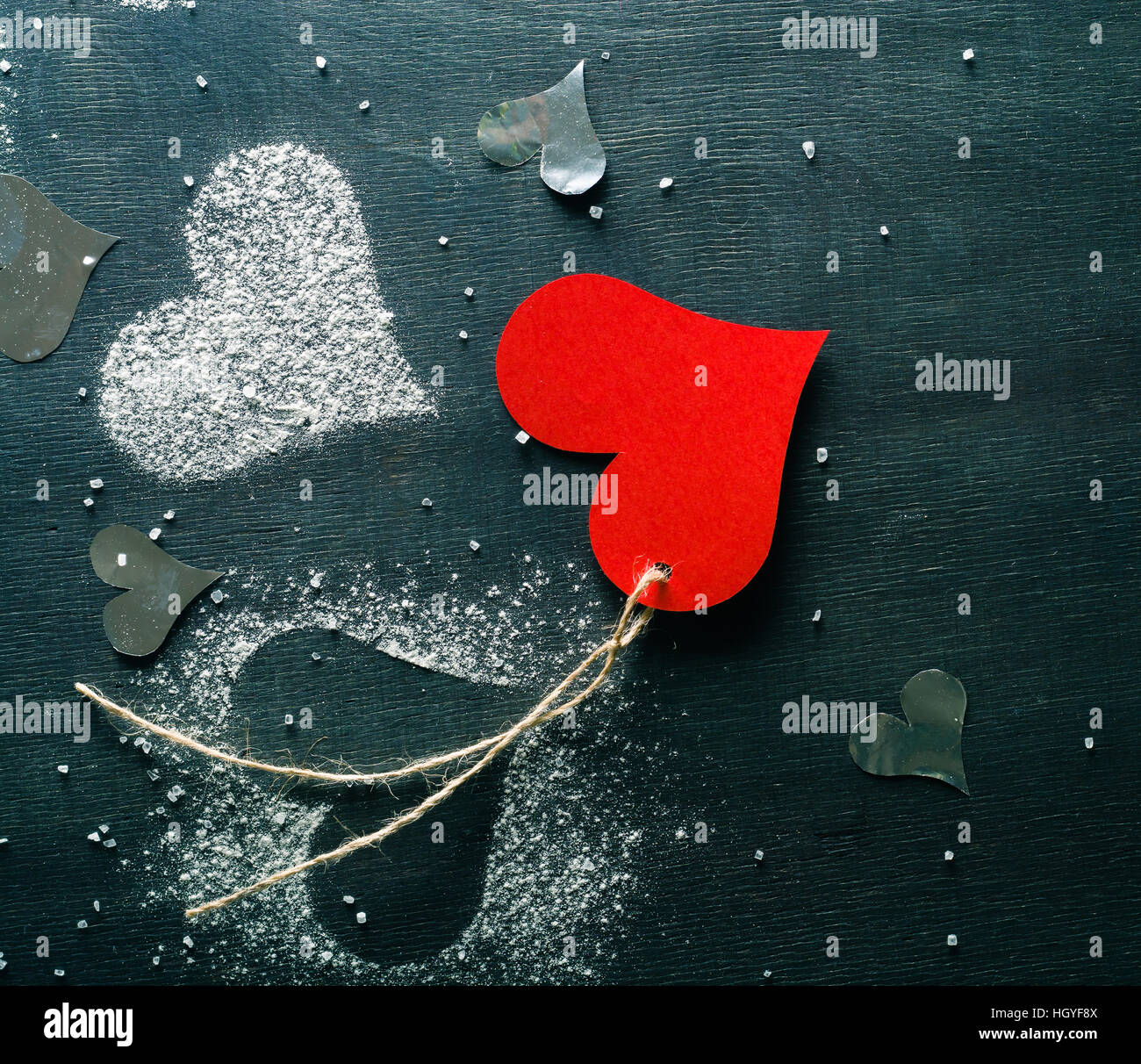 Card for Valentine's Day. Red paper heart on a rope. Strict dark ...