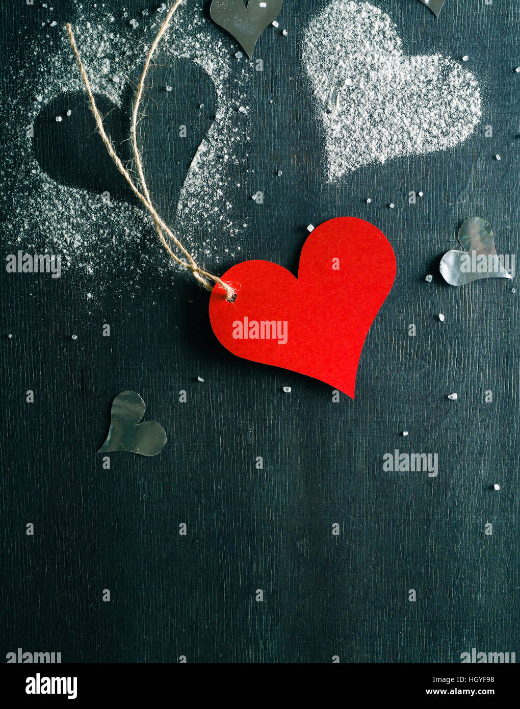 Card for Valentine's Day. Red paper heart on a rope. Strict dark ...