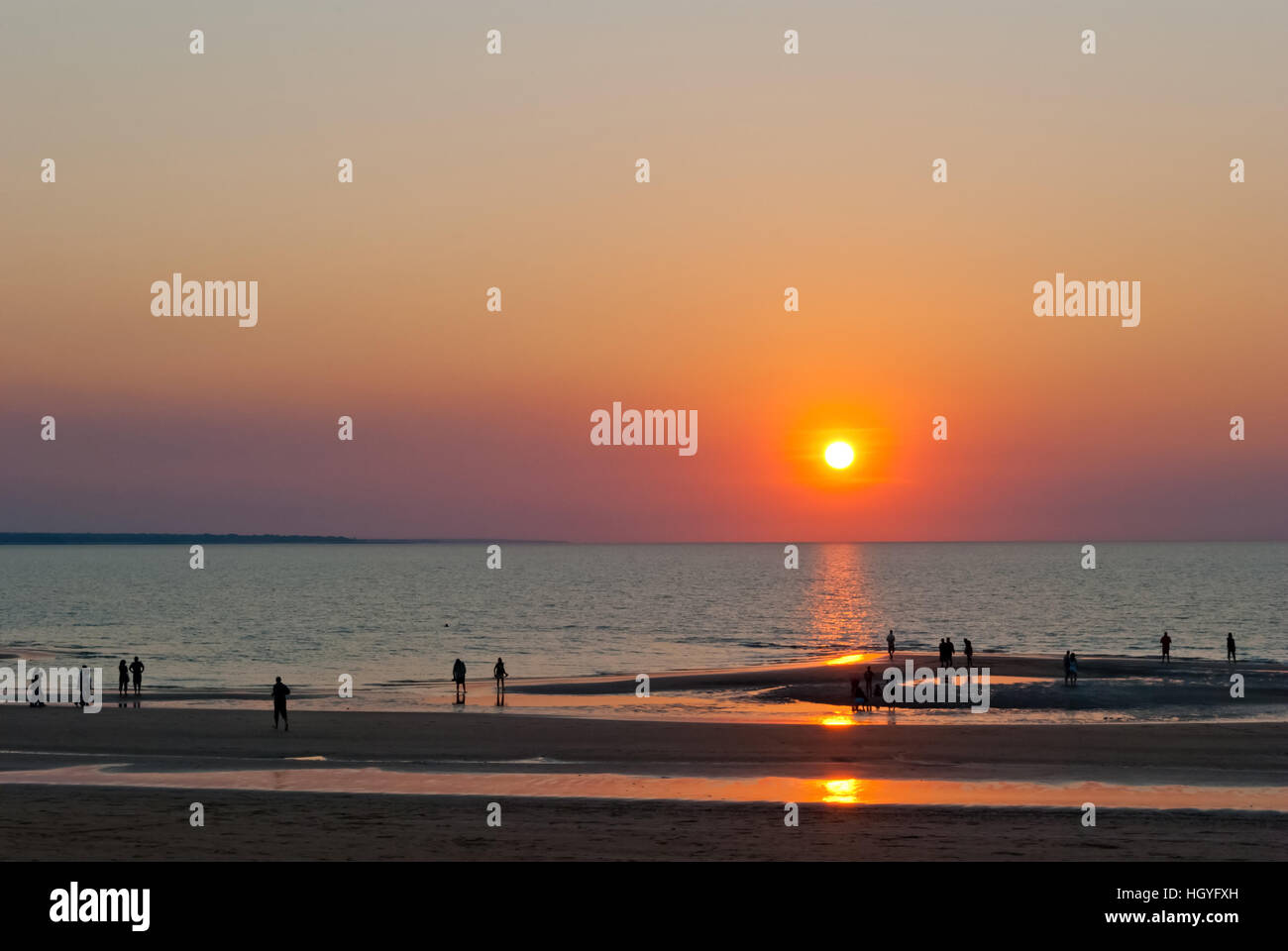 Romantic tropical sunset with people on the beach Stock Photo - Alamy