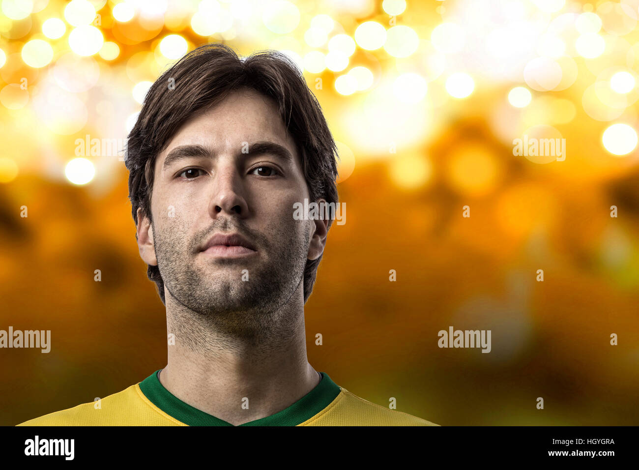 Brazilian soccer player, celebrating on a Yellow lights background ...