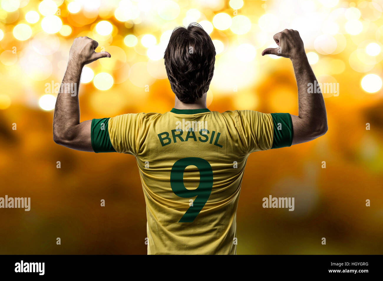 Brazilian soccer player, celebrating on a Yellow lights background ...