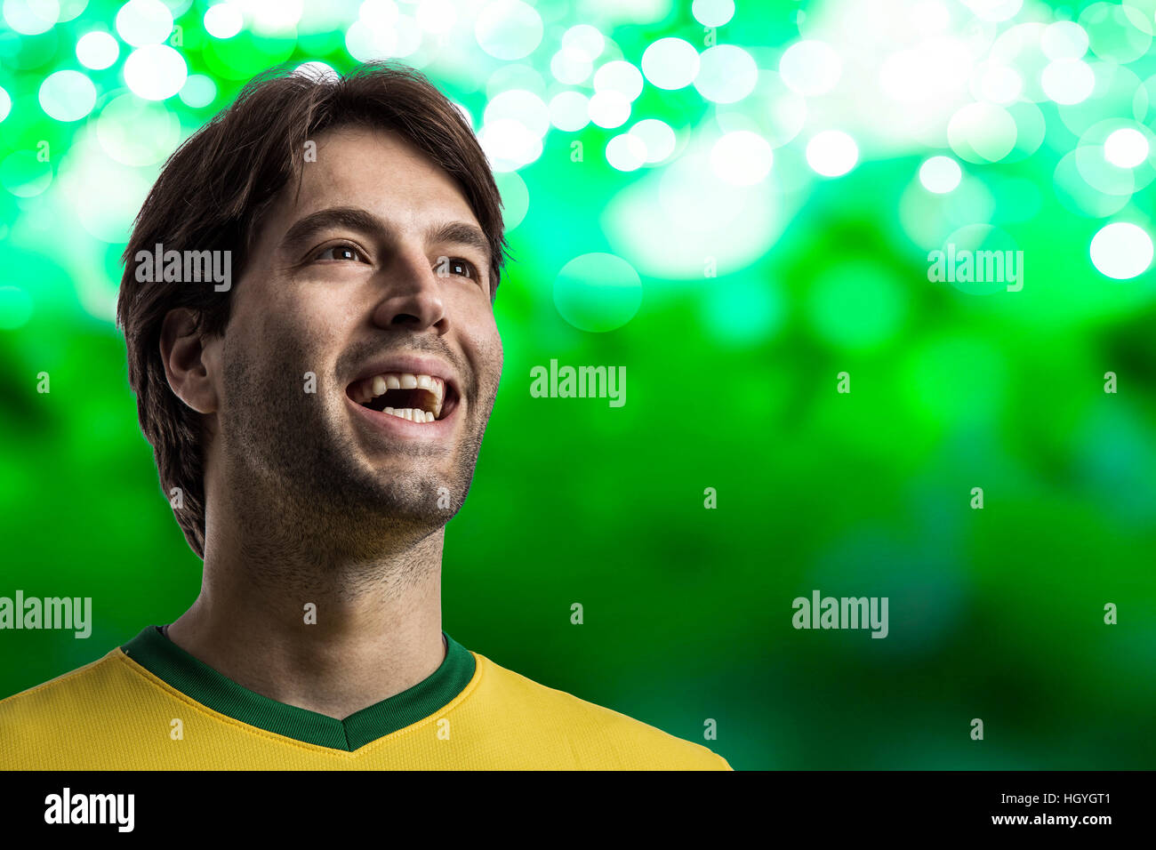 Brazilian soccer player, celebrating on a green lights background Stock ...