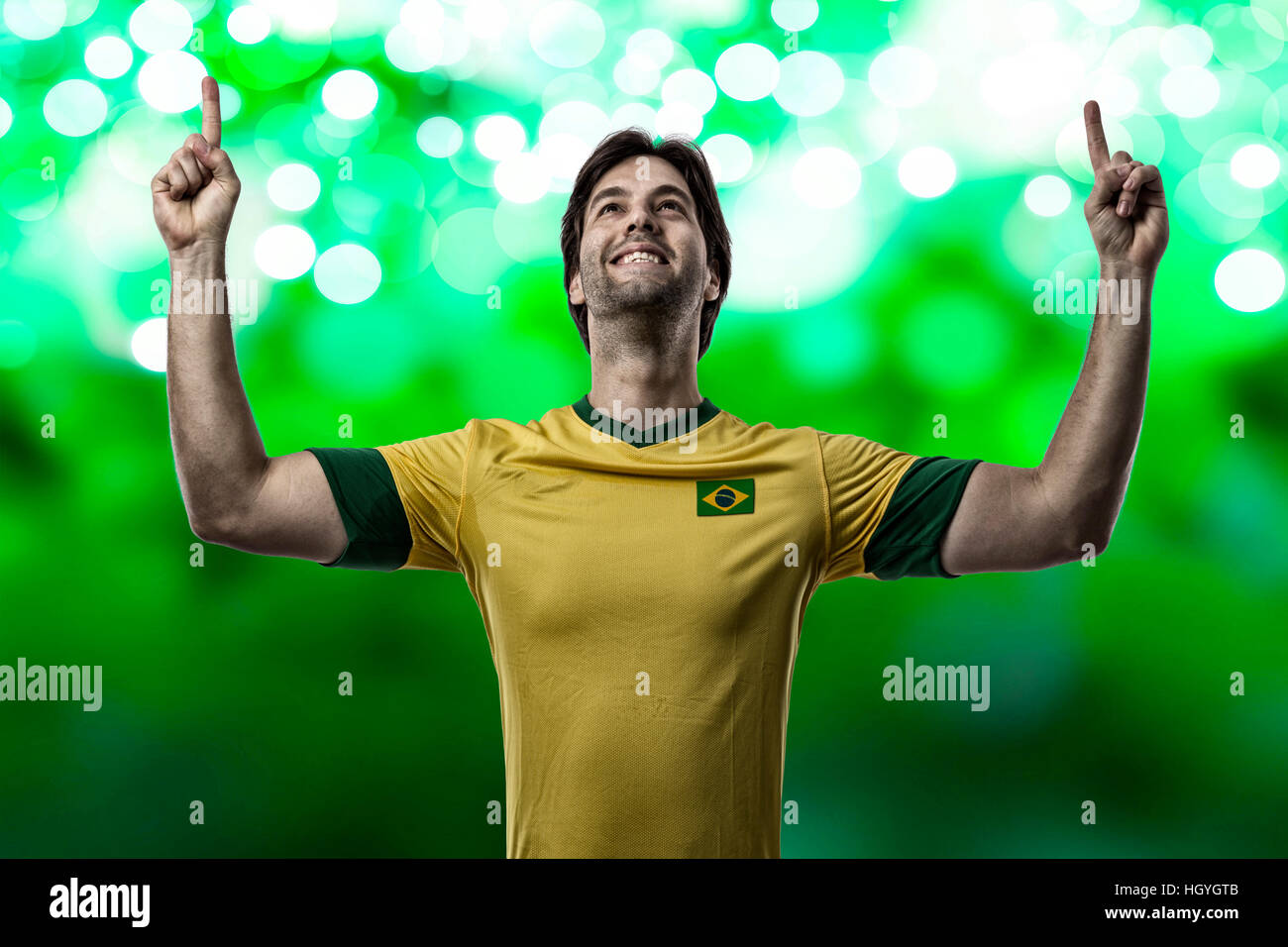 Brazilian soccer player, celebrating on a green lights background Stock ...