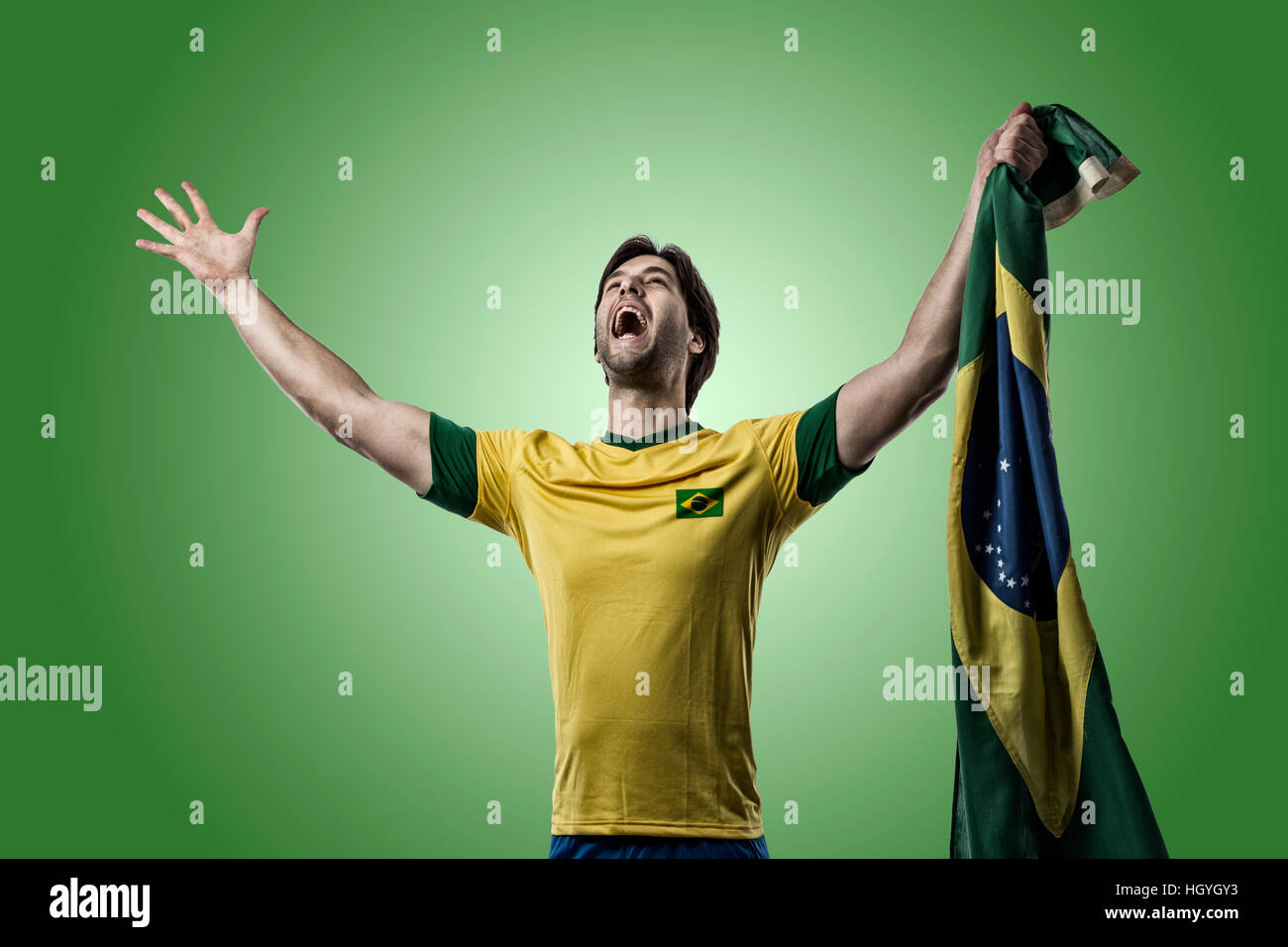Brazilian soccer player, celebrating on a green background Stock Photo ...