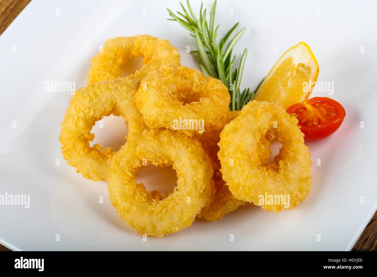 Fried Calamari rings with rosemary and lemon Stock Photo - Alamy