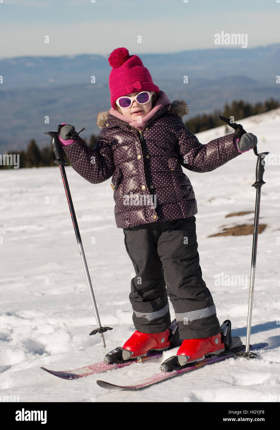 a happy little girl skiing downhill Stock Photo - Alamy