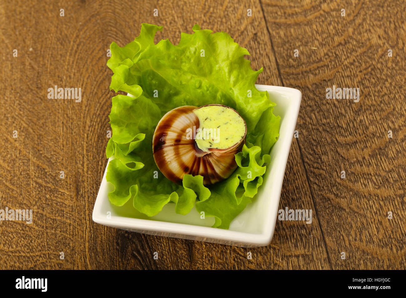 Escargot with cheese cream on salad leaves Stock Photo - Alamy