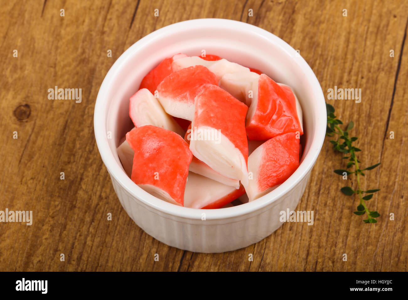 Crab stick - surimi in the plate - over wood background Stock Photo - Alamy
