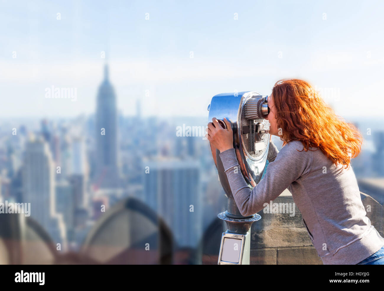Woman looking in observation binoculars Stock Photo - Alamy