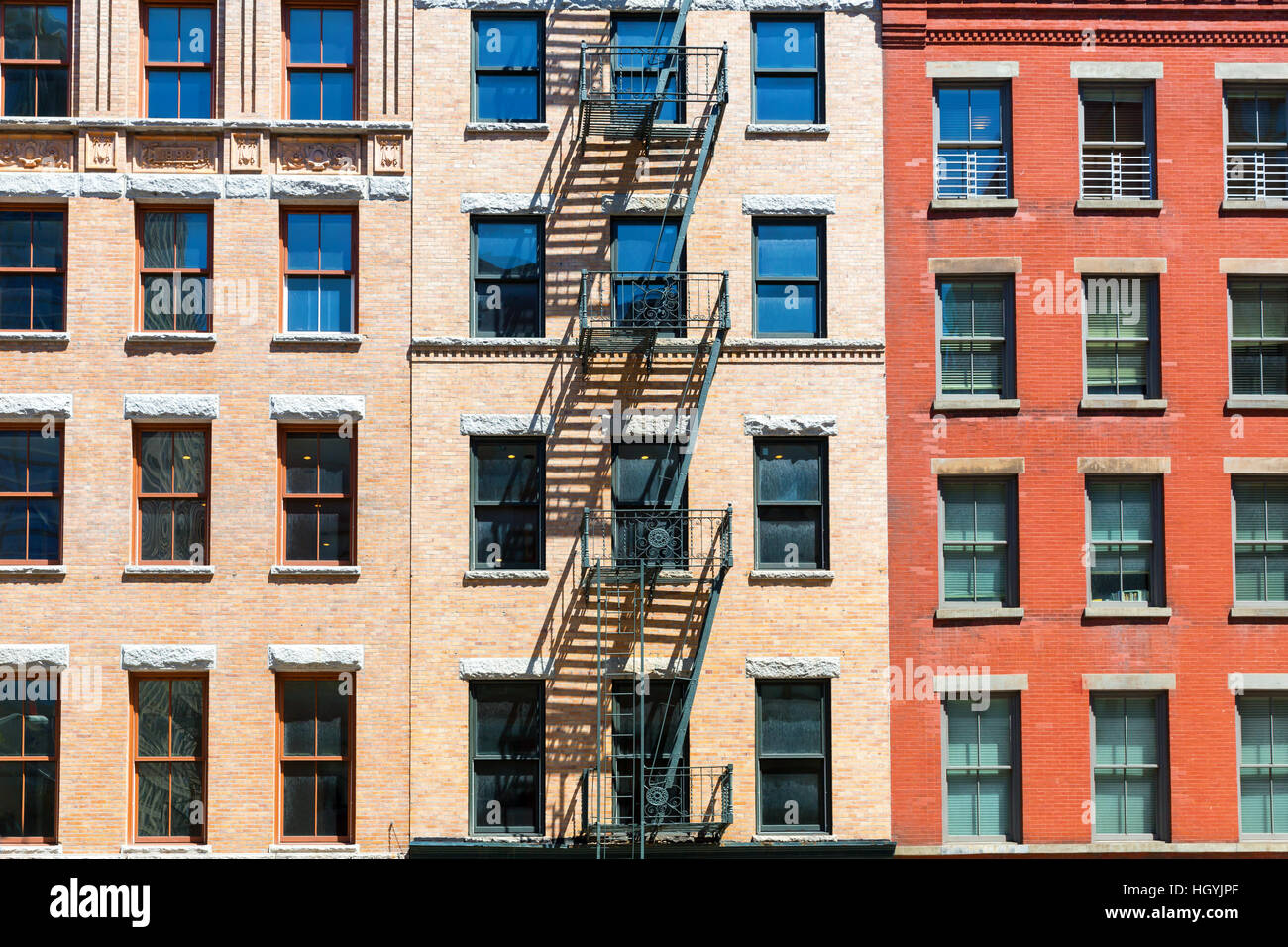 Facade of brick building with fire ladders Stock Photo - Alamy