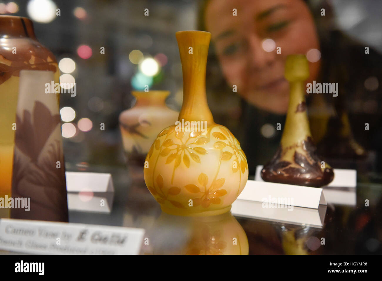 London, UK. 13 January 2017. A stall-holder views a 1900 French glass ...
