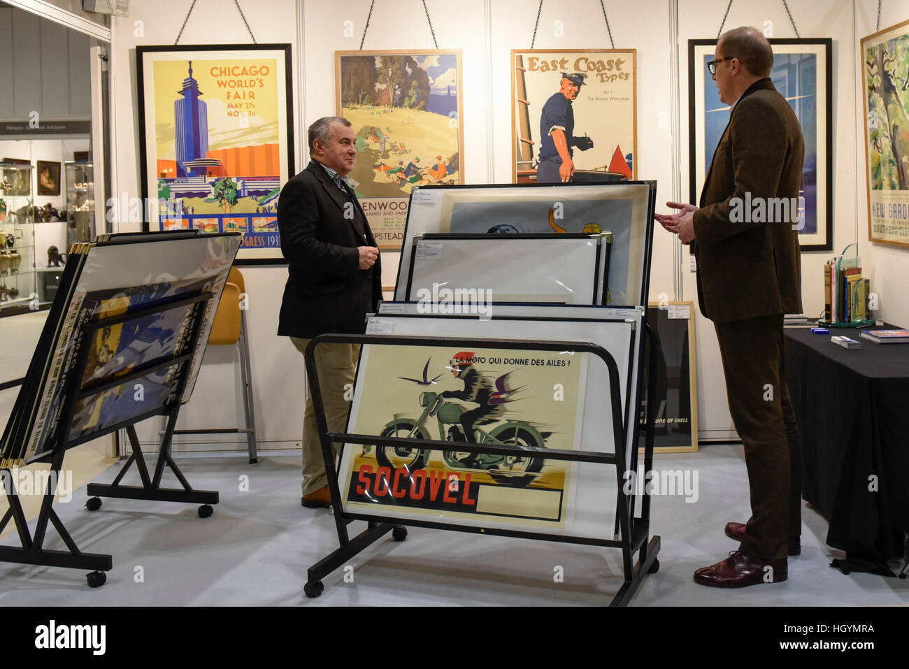 London, UK. 13 January 2017. Stall-holders discuss prints on display ...