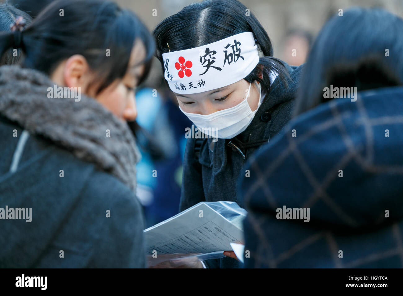 Tokyo, Japan. 14th Jan, 2017. Japanese students check their papers for ...