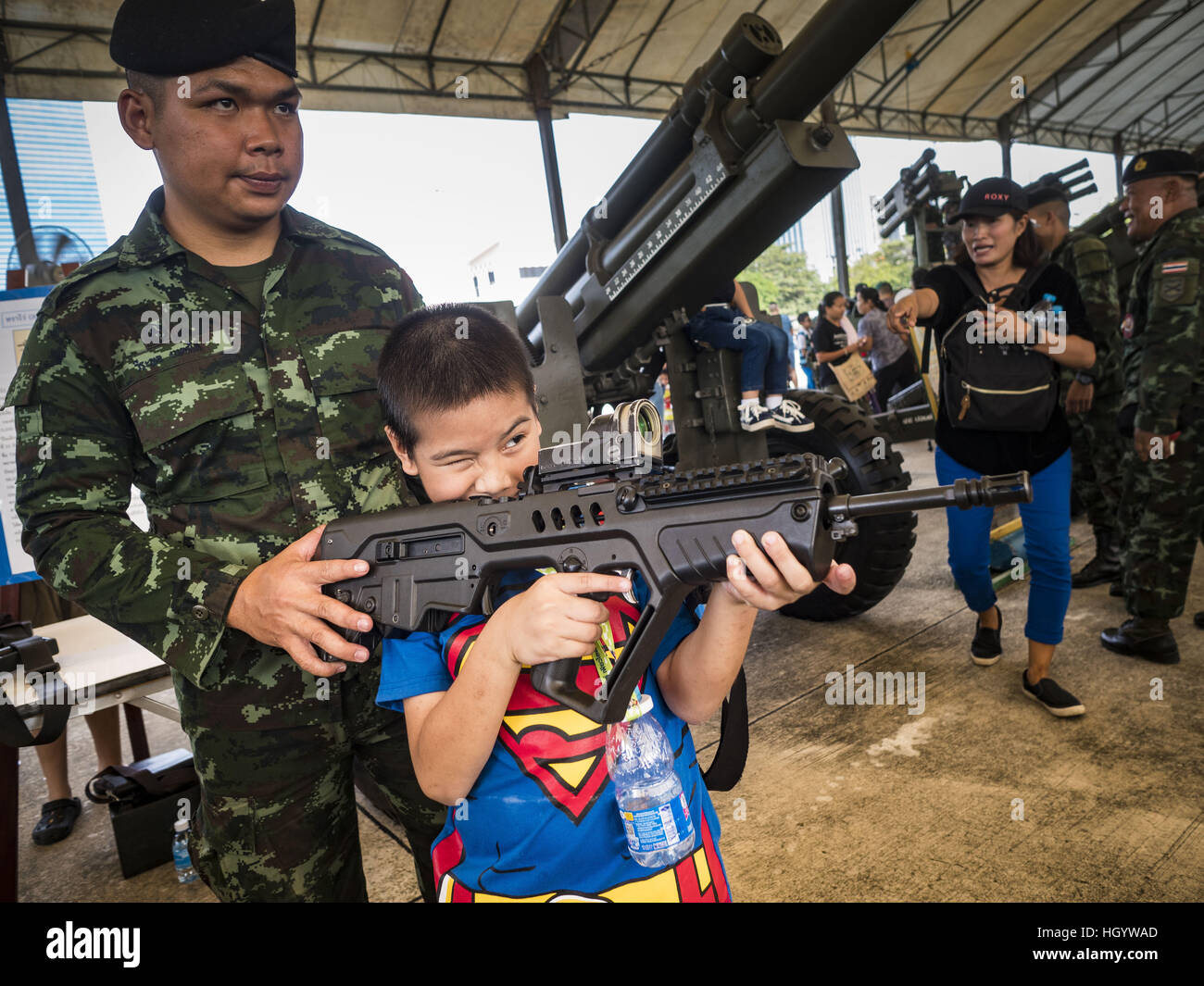 Bangkok, Thailand. 14th Jan, 2017. A child aims an empty Royal Thai ...