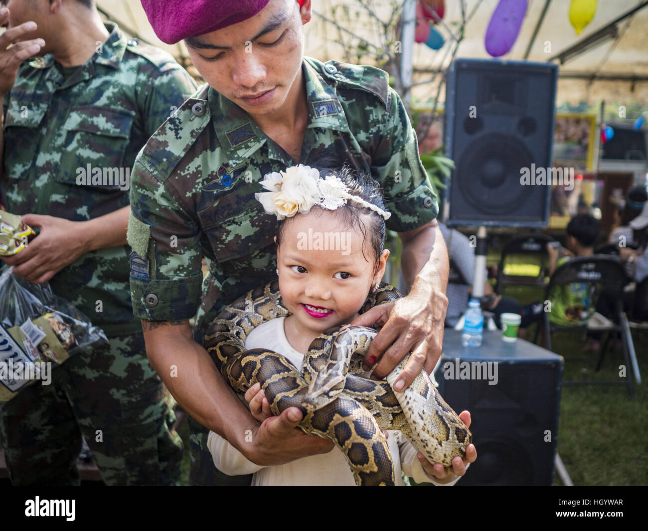 Bangkok, Thailand. 14th Jan, 2017. A Thai soldier puts a python around ...