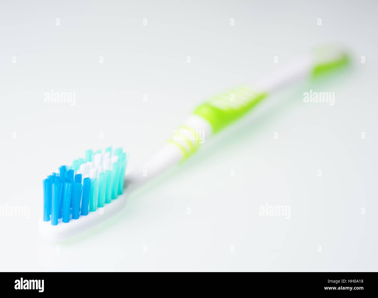 one toothbrush on a white table Stock Photo - Alamy